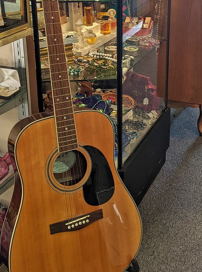 An acoustic guitar leans casually against a jewelry case, ready to serenade someone with songs from another era.