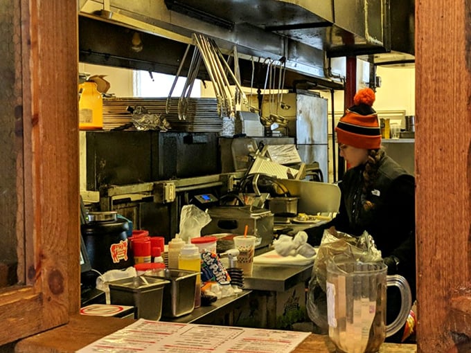 Where the magic happens &ndash; a glimpse into the kitchen reveals the organized chaos behind barbecue perfection. Those hands know what they're doing.