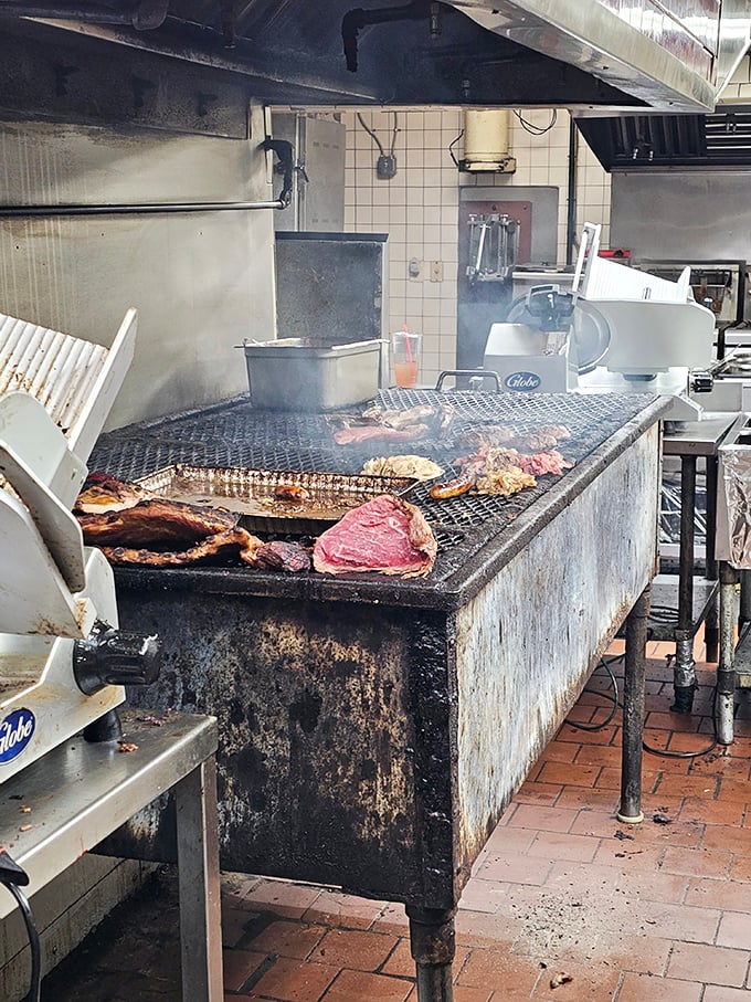 Where the magic happens! The well-seasoned pit reveals the secret behind Chaps' legendary meats&mdash;open flame, smoke, and years of barbecue wisdom.