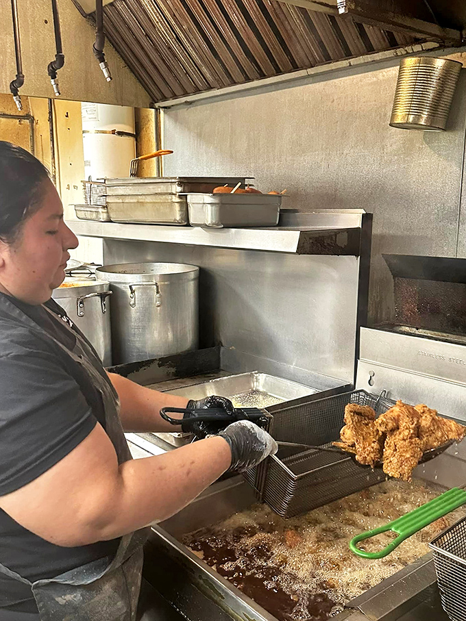 Behind every perfect piece of fried chicken is someone who knows exactly when that golden-brown moment of perfection arrives.