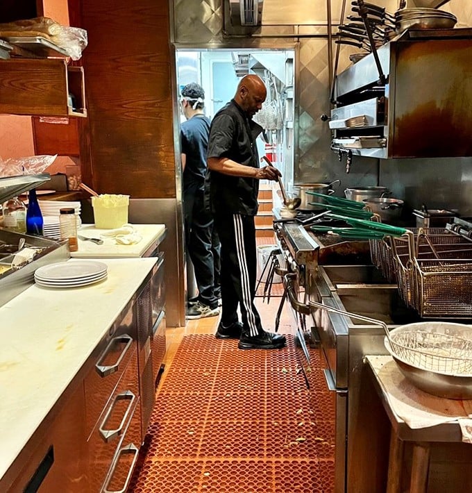 Behind the scenes in the compact kitchen where fresh Alaskan ingredients are transformed into memorable meals with practiced efficiency.