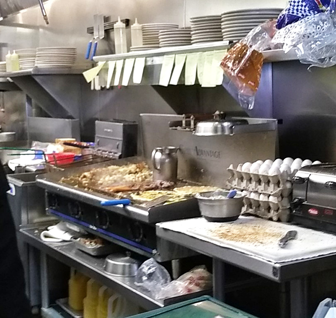 The kitchen pass&mdash;where breakfast magic happens amid organized chaos, with order tickets and egg cartons standing by for the next round.