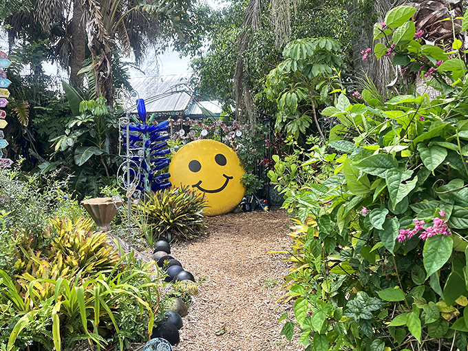 Nothing says "welcome to happiness" quite like a giant yellow smiley face peeking through tropical foliage. Instant mood elevation guaranteed.