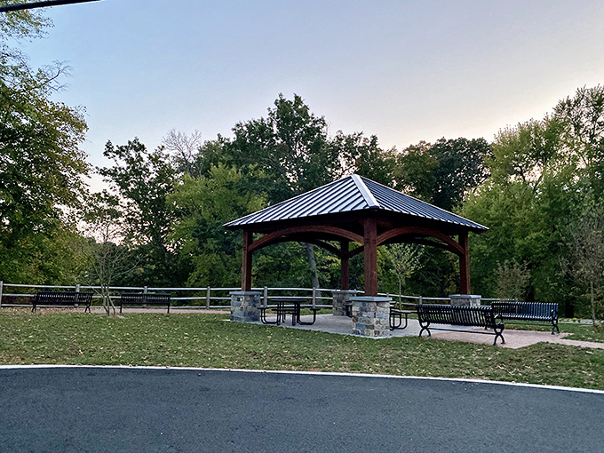 Beyond the blooms, this gazebo offers a moment to sit and contemplate how you're going to explain to your garden at home why you're looking at other flowers.