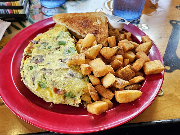 This isn't just an omelet&mdash;it's a morning masterpiece with more fillings than your average novel has plot twists. Those home fries aren't playing supporting roles; they're co-stars.