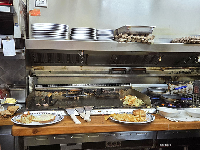 Where breakfast magic happens: A well-seasoned griddle that's seen more eggs than a chicken farm and knows exactly how your hash browns should crisp. 