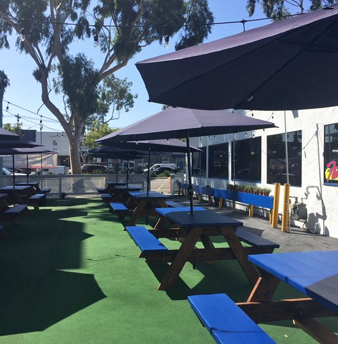 Outdoor dining that says "I want my pancakes with a side of California sunshine." Blue tables match the San Diego sky.