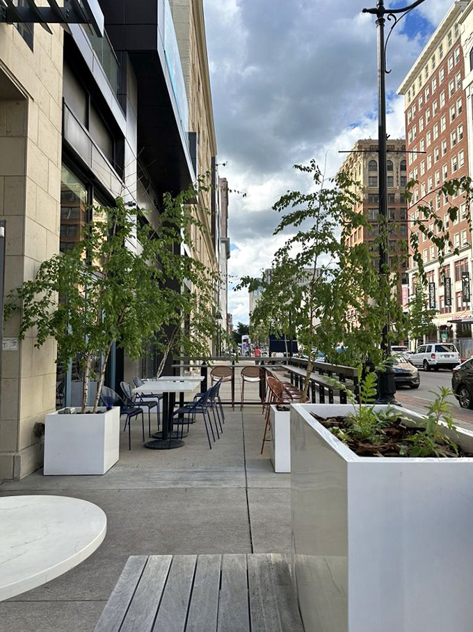 Outdoor seating that transforms downtown Columbus into a European-style dining experience, where city energy meets al fresco tranquility between thoughtfully placed planters.