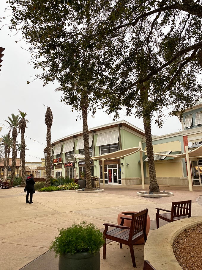Palm trees and outdoor seating areas provide peaceful respites where shoppers can recharge under Texas skies.