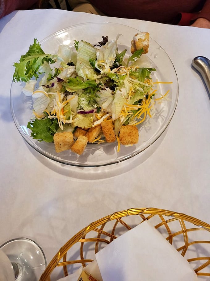 Even the house salad gets the star treatment&mdash;crisp greens, shredded cheese, and homemade croutons proving that simple can be spectacular.