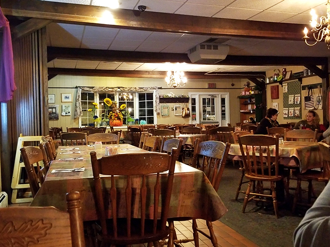 Evening ambiance that strikes the perfect balance between "special occasion" and "come as you are"&mdash;note the chandeliers casting a warm glow over wooden tables. 