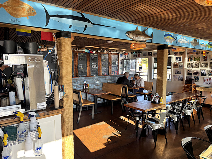 Fish models swim eternally above diners in this maritime-themed interior where wooden beams echo the hulls of boats outside.