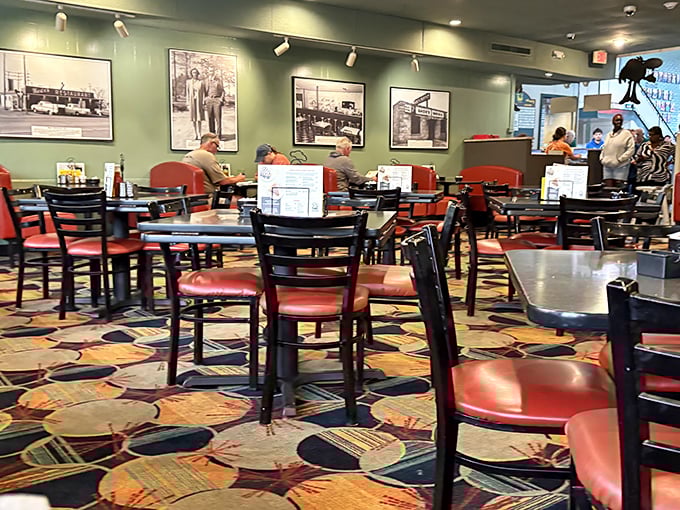 Red chairs invite you to settle in for a proper Southern meal. The colorful carpet might be hiding gravy stains from decades of enthusiastic eating.