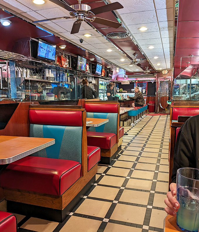 The classic diner interior &ndash; where red vinyl booths and checkered floors create a time capsule where calories don't count and coffee refills are practically mandatory.
