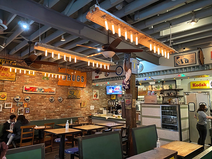 Green booth seating and brick walls provide the comfortable setting where marathon brunches naturally unfold over multiple coffee refills.