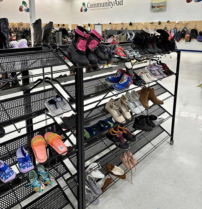 The shoe section: a podiatric United Nations where hiking boots and beach flip-flops find common ground on metal shelving.