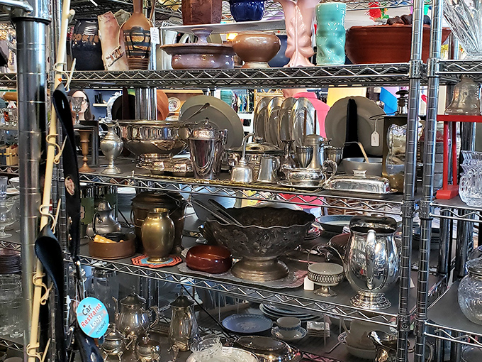 Silver serving pieces gleam under fluorescent lights, ready to elevate your next dinner party from takeout containers to vintage elegance.