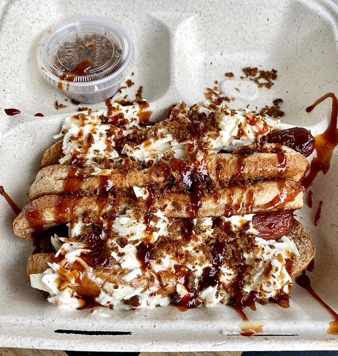 These aren't just hot dogs; they're smoke-infused flavor delivery systems topped with enough goodies to make condiment lovers swoon.