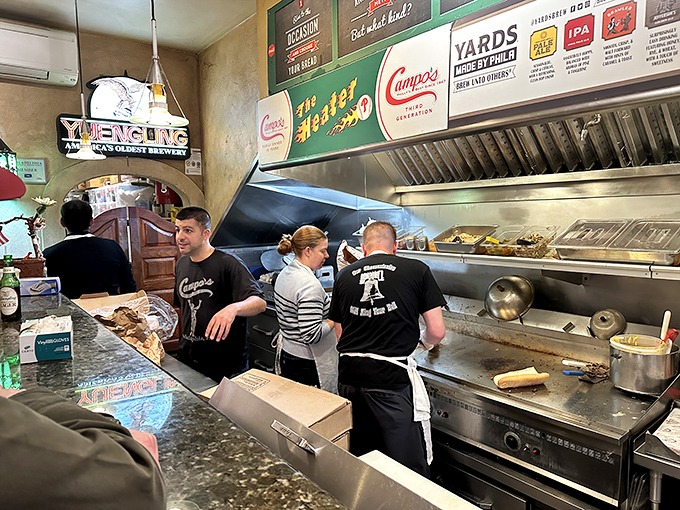 The sandwich artists of Campo's in their element &ndash; choreographing a ballet of spatulas, meat, and cheese with practiced precision.