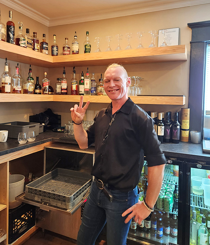 Behind every great restaurant is a passionate staff. This friendly face at the bar suggests you're not just getting drinks—you're getting hospitality with personality.