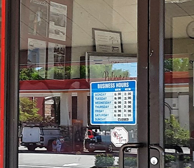 Business hours posted like a promise—because when you're craving those biscuits and gravy, you need to know exactly when to show up.