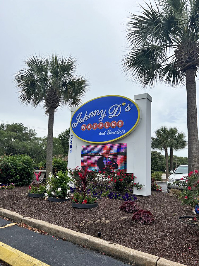Palm trees frame the cheerful signage like nature's exclamation points, announcing "Breakfast worth stopping for!" to passing travelers.