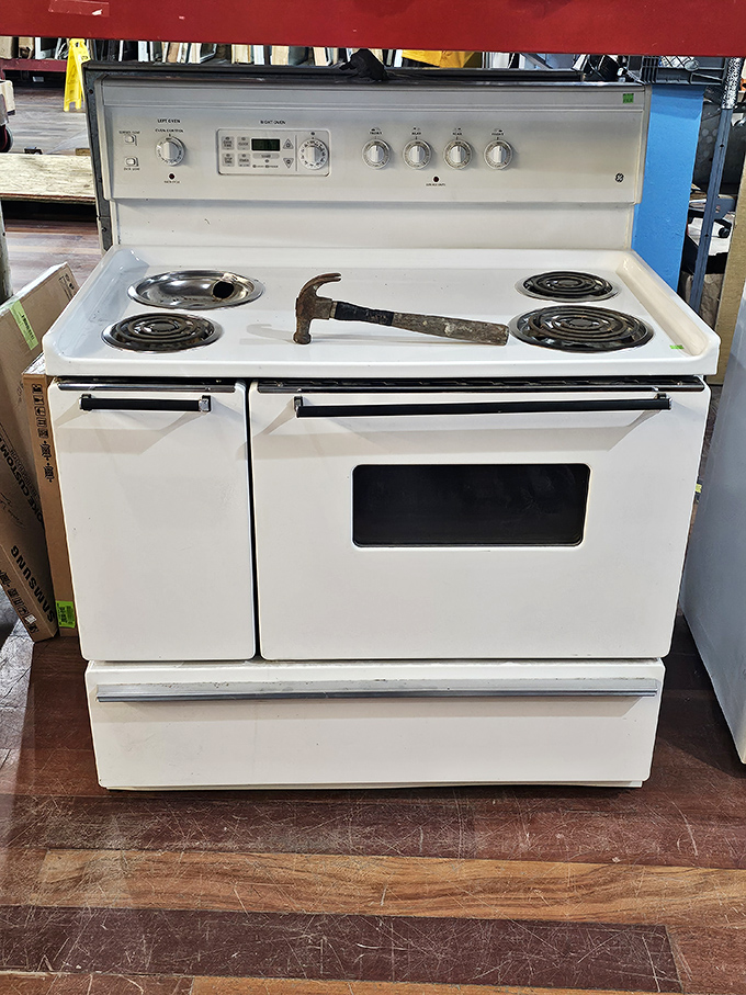 That stove has seen more family dinners than a holiday sitcom special—and the hammer is just staging a temporary rebellion.