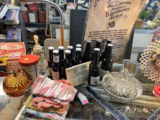 Homemade elderberry syrup sits among vintage treasures. A taste of New Hampshire's natural bounty, bottled with care and traditional know-how.