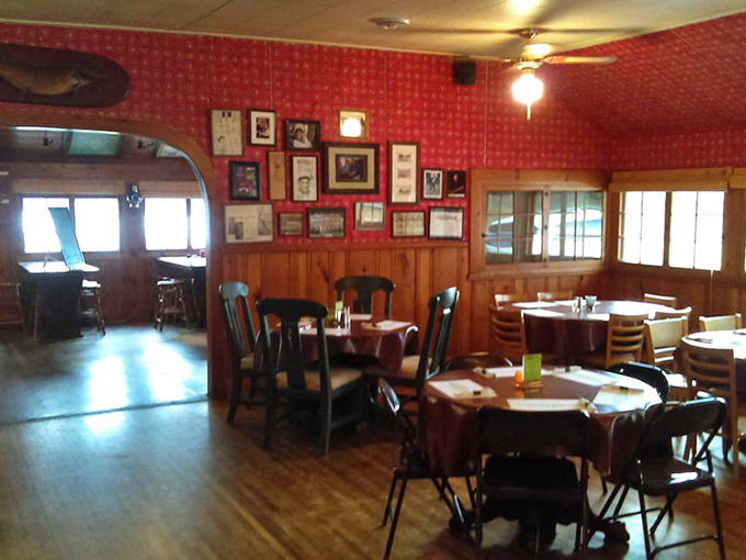 Red wallpaper and wooden wainscoting create that perfect "grandma's fancy dining room meets fishing lodge" vibe that defines Minnesota charm.