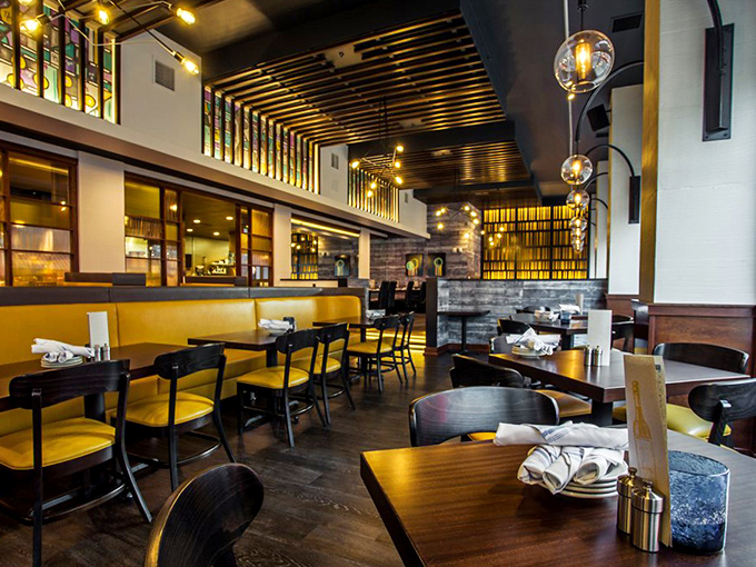 Yellow banquettes pop against dark wood in a space where Montana casual meets big-city sophistication without any pretension.