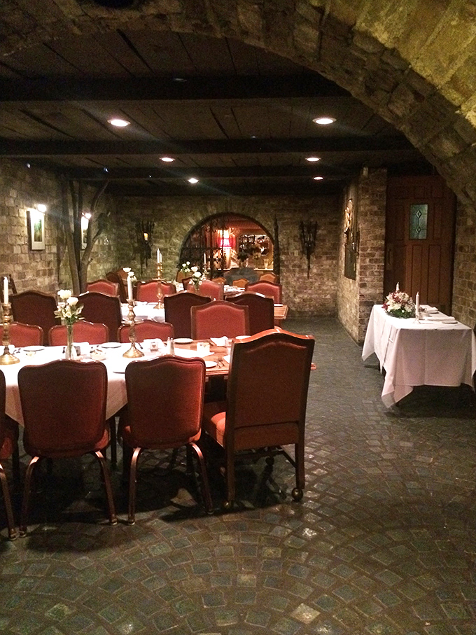 Stone archways and intimate table settings create dining spaces that feel like you've discovered a secret room in a medieval castle.