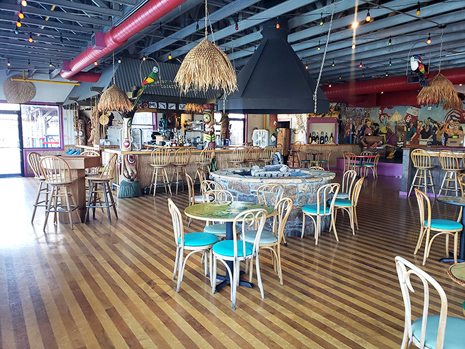 The tiki-inspired dining area offers a playful escape, where striped floors and colorful chairs set the stage for seafood celebrations.