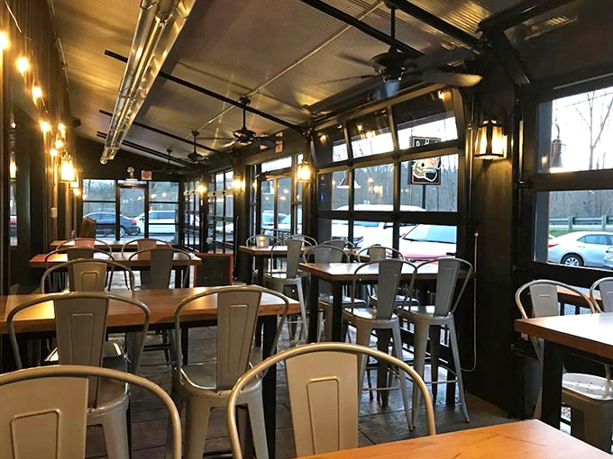 Modern meets rustic in this dining area, where industrial lighting and metal chairs create the perfect backdrop for serious steak contemplation.