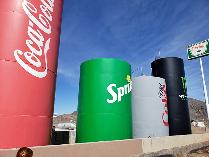 Morning light catches the vibrant colors of these tanks-turned-treasures, making them glow like beacons for thirsty travelers.