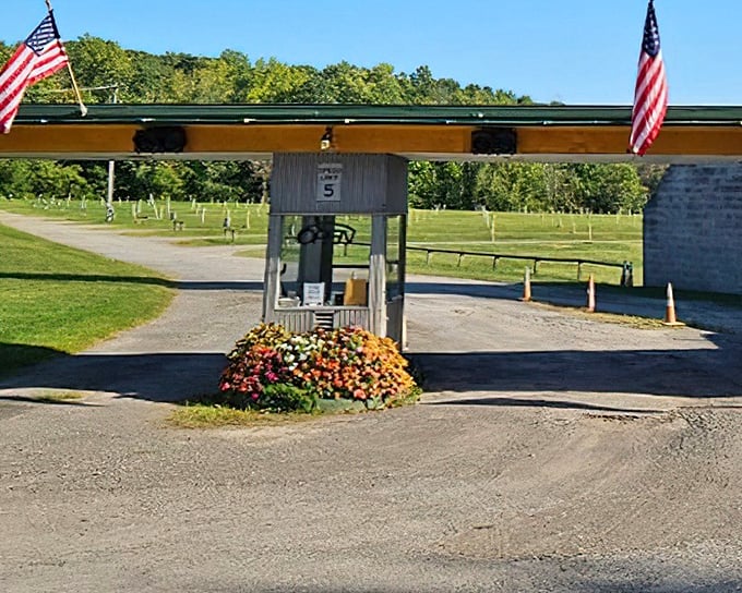 The gateway to nostalgia, complete with American flags and flower baskets. Not just an entrance booth, but a time portal to simpler summer nights.