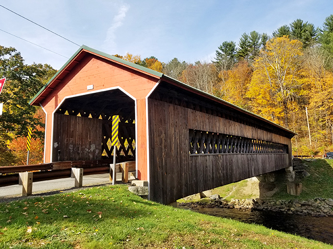 Fall foliage creates the perfect golden-red frame for this wooden masterpiece against a brilliant blue October sky.