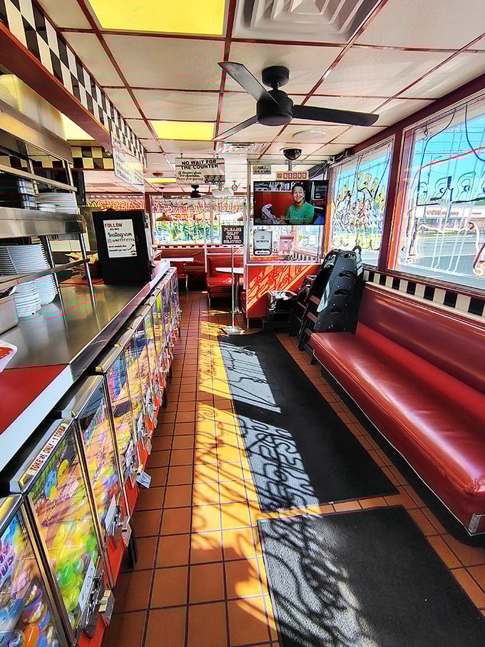 Sunshine streams through windows, painting the red vinyl booths with golden light. This isn't just a waiting area&mdash;it's the prelude to pleasure.