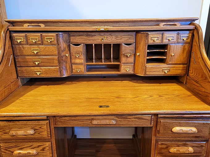 This roll-top desk has probably seen more tax seasons than your accountant. Those tiny drawers once organized someone's life&mdash;now they await yours.