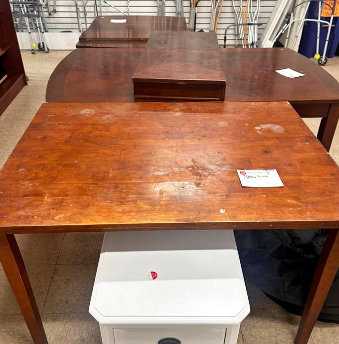 Solid wood tables with character marks tell stories of family dinners past, ready for new memories at a fraction of retail cost.