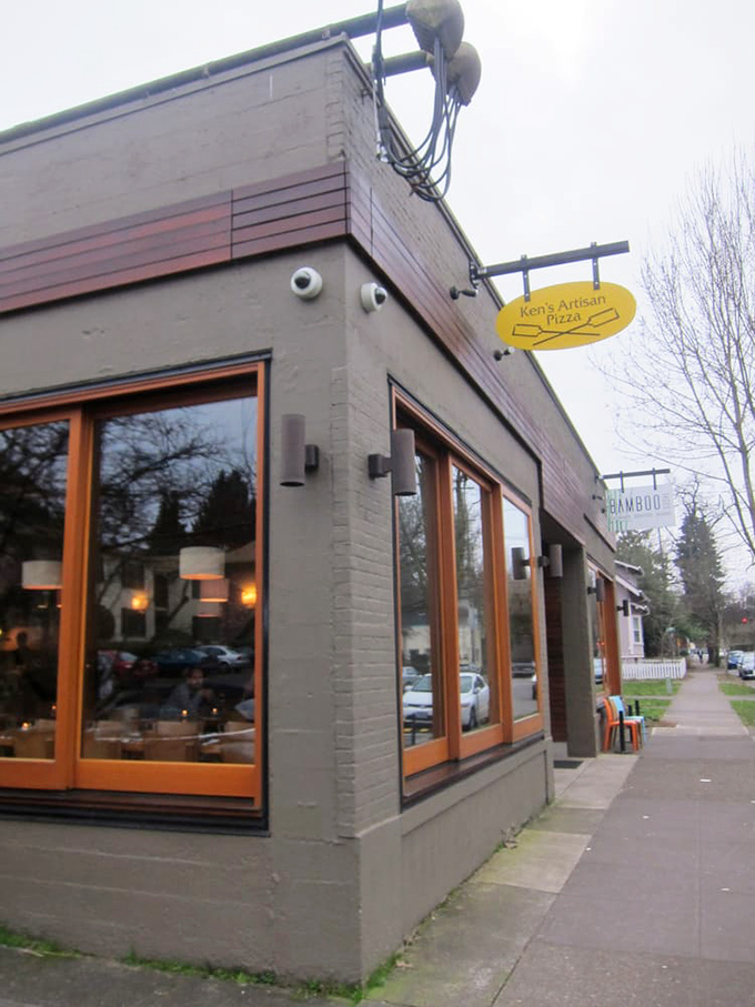 Ken's Artisan Pizza's simple brick exterior with large windows offers tantalizing glimpses of wood-fired magic happening inside.