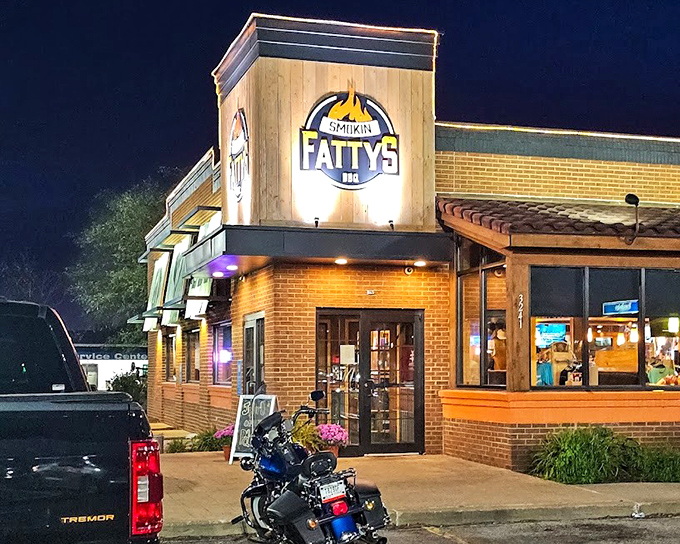 Smokin Fattys' nighttime glow is like a BBQ lighthouse guiding hungry sailors to port. That wooden accent wall screams "authentic!"