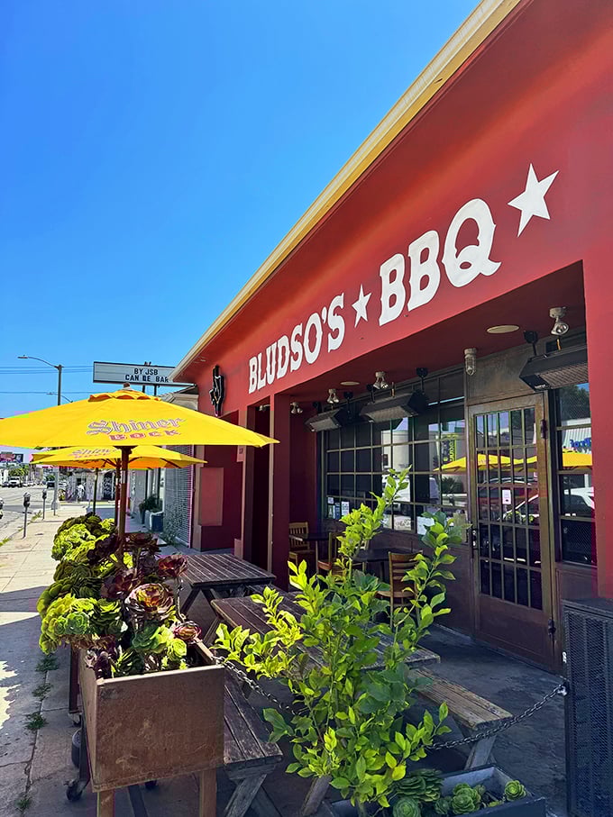 Those yellow umbrellas and green plants create an urban BBQ oasis where LA style meets Texas smoking traditions.