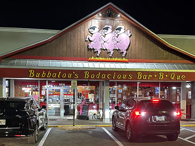 Night falls but Bubbalou's lights shine bright like a BBQ beacon. Those three pigs aren't just a logo &ndash; they're a promise.