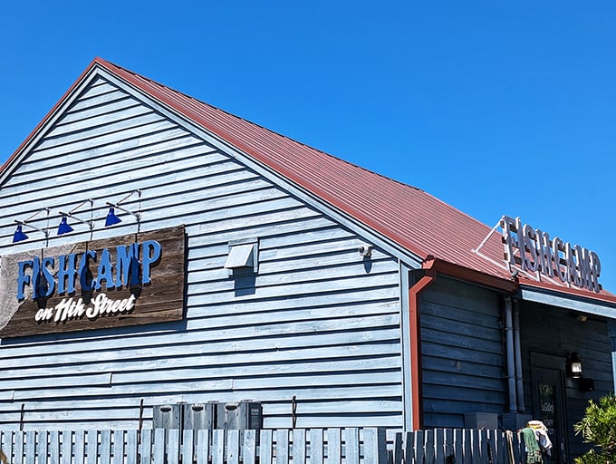 The sun highlights Fishcamp's classic coastal architecture and inviting entrance. Where "fish camp" isn't just a name—it's a delicious way of life.