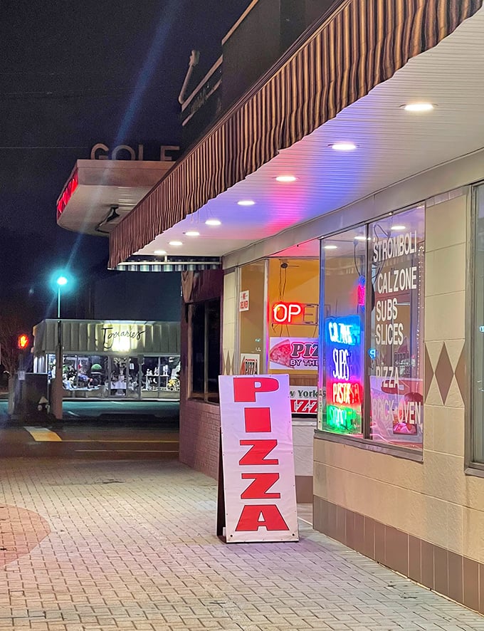 That classic pizza joint glow promises the kind of late-night slices that make beach vacations absolutely unforgettable.