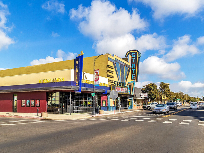 The State Theatre's vibrant blue and yellow fa&ccedil;ade brightens downtown Modesto, a splash of art deco color against the California sky.