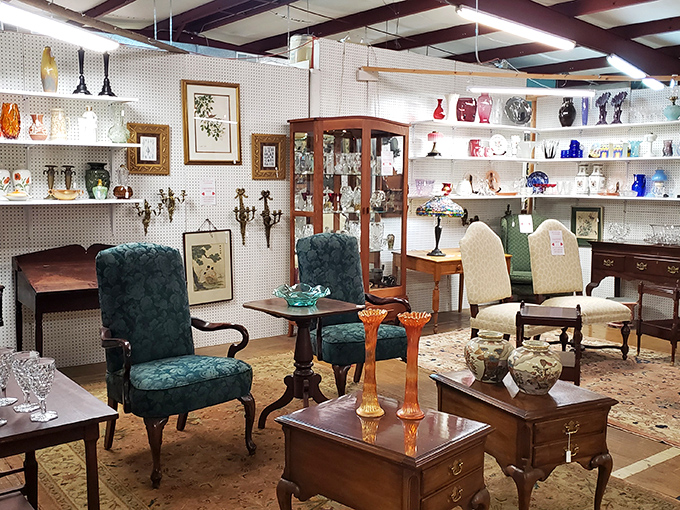 The emerald armchairs look like they're having a sophisticated conversation about the orange candlesticks that just walked into the room.