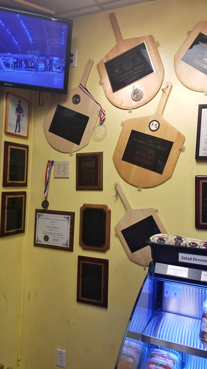 A wall of wooden paddles transformed into award plaques &ndash; the pizza equivalent of Olympic gold medals lining the walls.