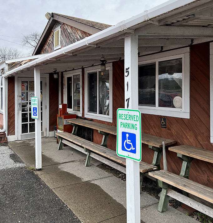 This weathered storefront with rustic benches offers the kind of authentic dining experience food critics dream about but rarely find.
