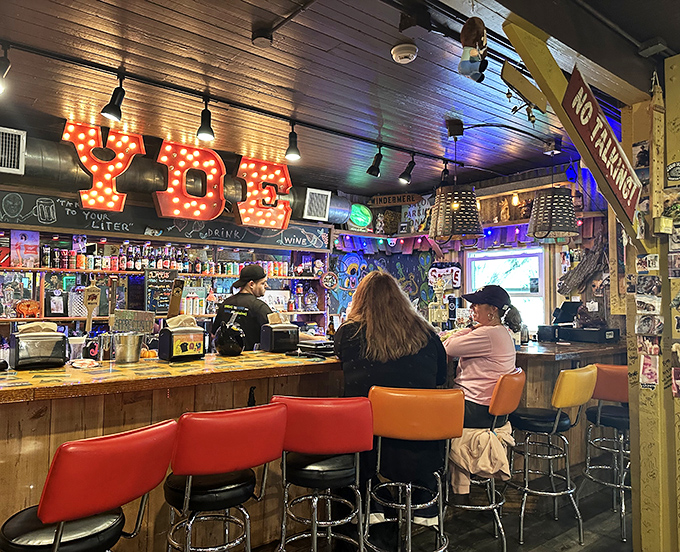 The bar's neon "YDE" sign glows like a BBQ lighthouse, guiding hungry souls toward salvation in the form of craft beers and pulled pork.